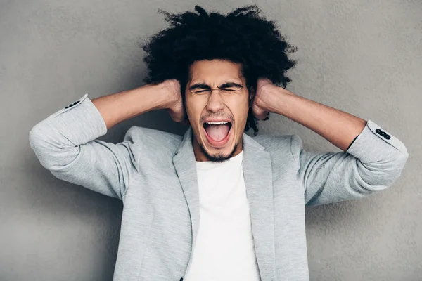 African man covering ears - Stock Image - Everypixel