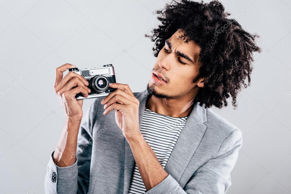 African man holding retro camera Stock Photo by ©gstockstudio 99105728