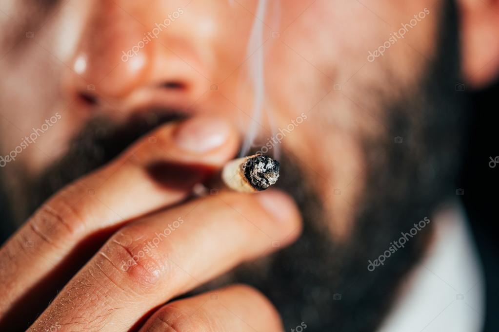 Smoking cigarette pose — Stock Photo © razyphoto #118790012