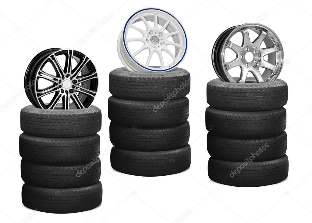 Car alloy wheels on pile tires Stock Photo by ©koydesign 53955391