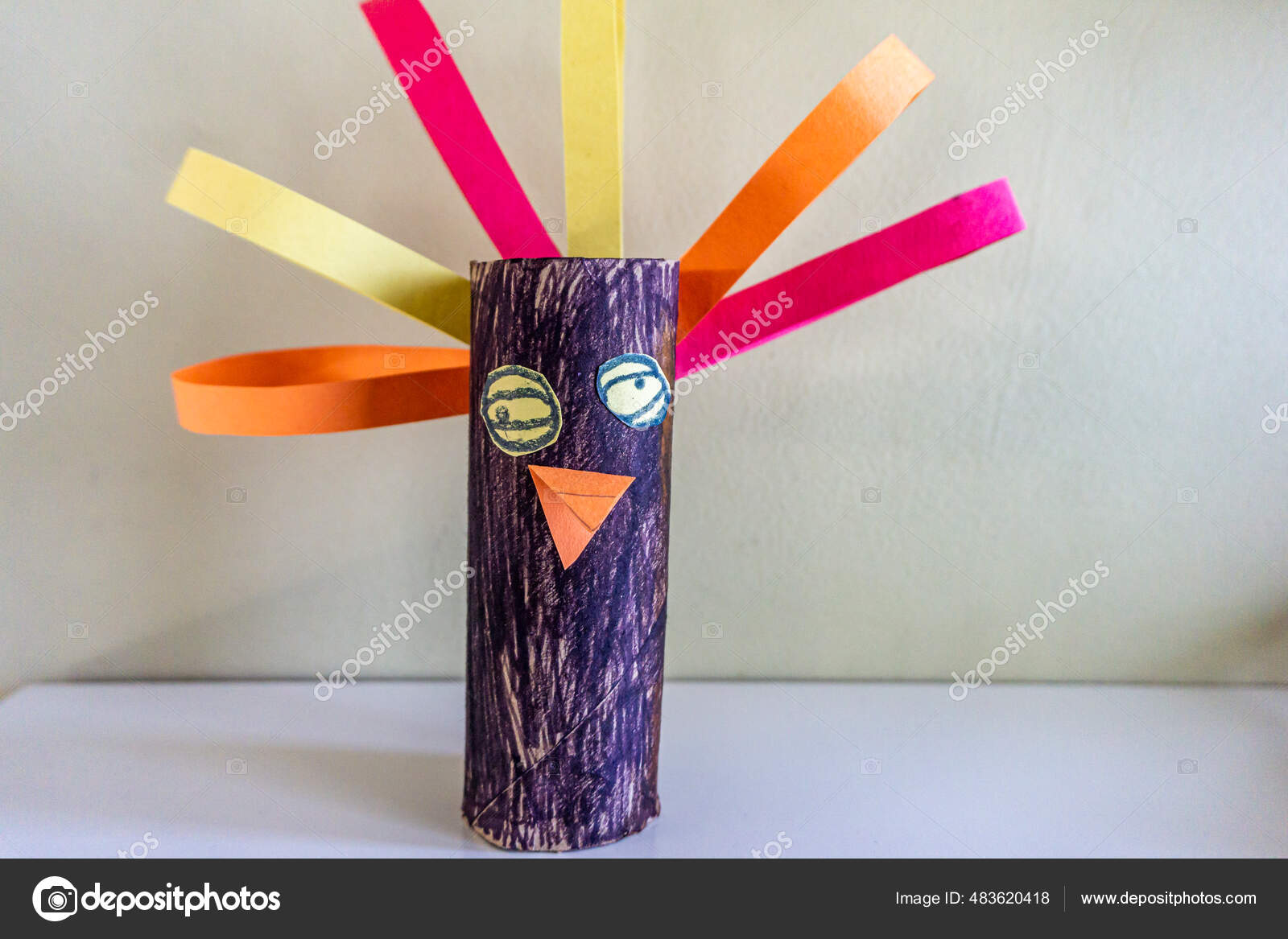 Handmade craft by child representing a figure with eyes, nose and hair ...