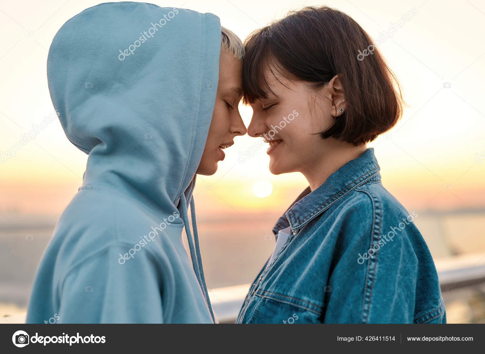 Close Up Of Young Loving Lesbian Couple Smiling While Going To Kiss