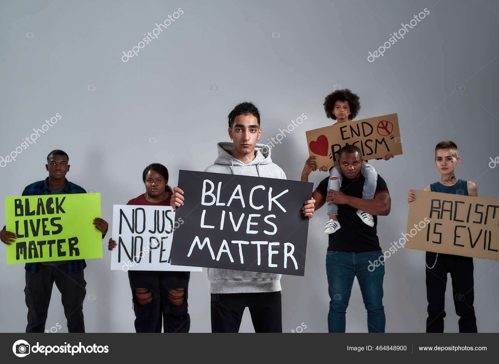 Young gypsy man standing with anti racist posters — Stock Photo ...