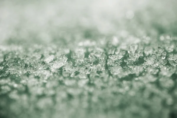 Tiny ice pieces on a plastic surface, winter background and texture ...