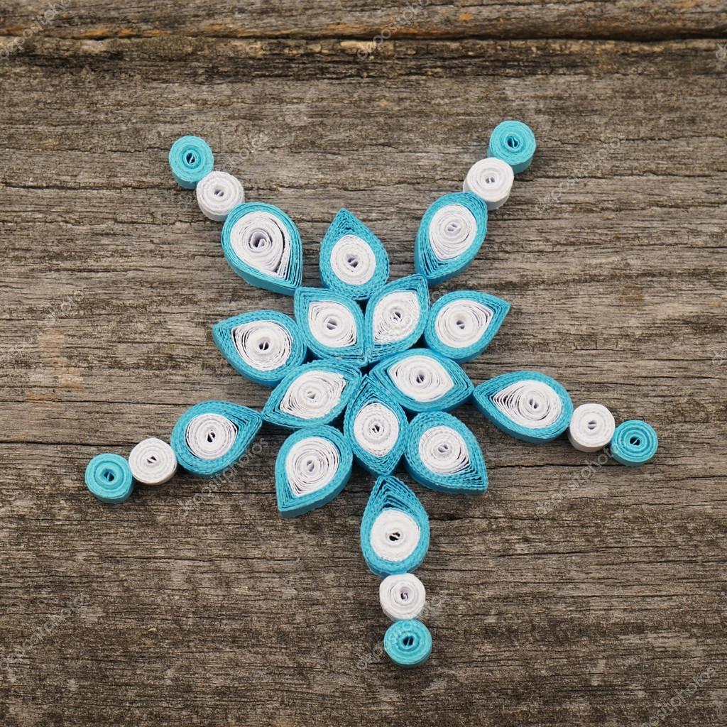 Paper snowflakes made with quilling technique on a wooden surface Stock ...
