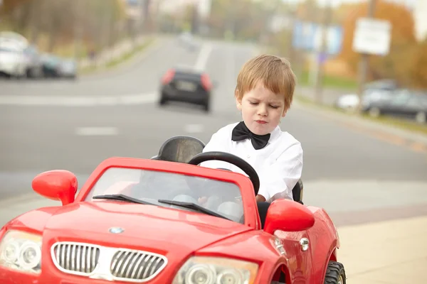 Little boy driving car — Stock Photo © nikolodion #85382578