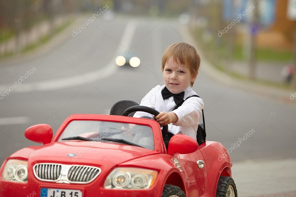 Little boy driving car Stock Photo by ©nikolodion 85382544