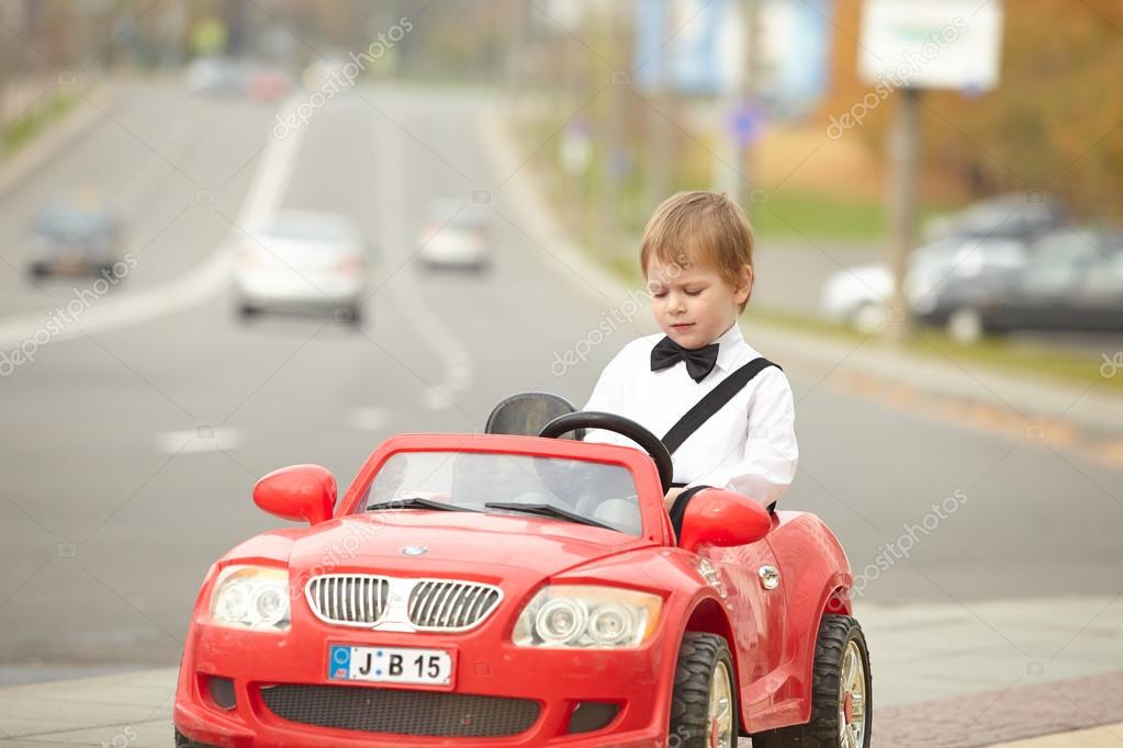 Little boy driving car — Stock Photo © nikolodion #85382564