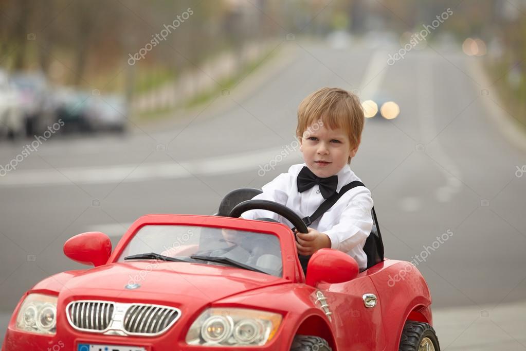 Little boy driving car — Stock Photo © nikolodion #85382604