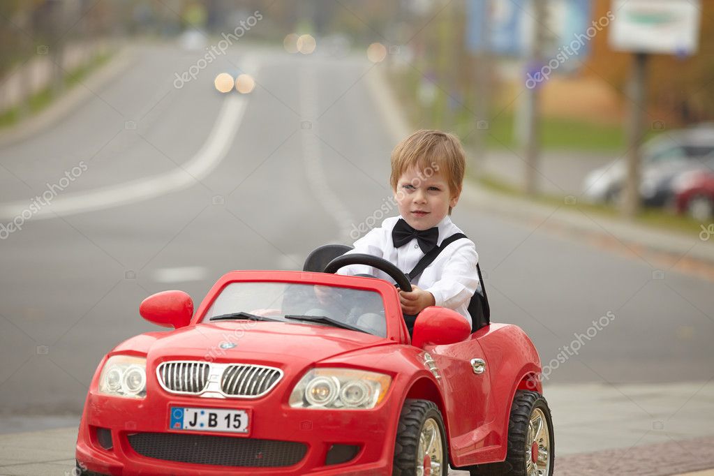 Little boy driving car — Stock Photo © nikolodion #85382828