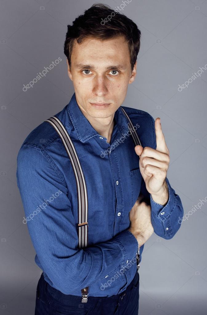 Young goofy man with pimples pointing in studio Stock Photo by ©iordani ...