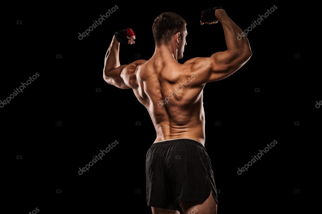 Rear view of healthy muscular young man with his arms stretched — Stock ...