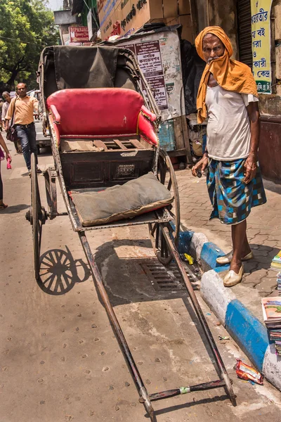 Man rickshaw puller is pulling his hand rickshaw on the street in ...