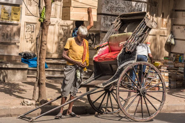 Man rickshaw puller is pulling his hand rickshaw on the street in ...