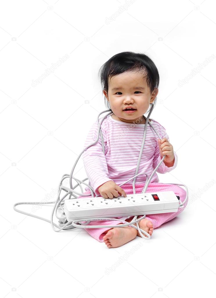 Baby playing with electricity wire Stock Photo by ©weerapat 72568559
