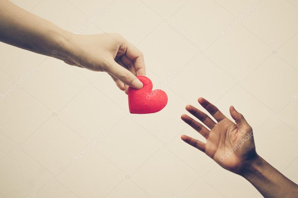 Hand giving a red heart to a male hand Stock Photo by ©weerapat 82549986
