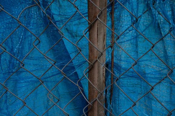 background in the form of a netting mesh and blue fabric - Stock Image ...
