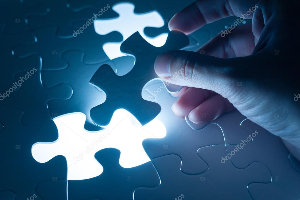 Hand insert jigsaw, conceptual image of business strategy, decis ...