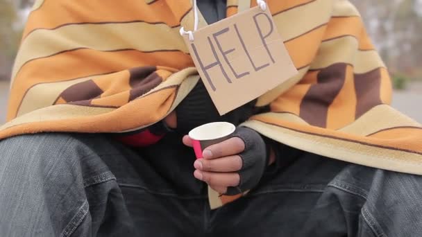 Poor man holding out hand with paper cup to camera, asking for help and ...