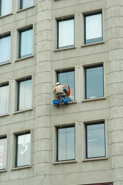 Window cleaner washing elevation of building windows - Stock Image ...