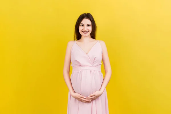 Happy pregnant woman touching her belly on white background fotos de stock, imágenes de Happy ...