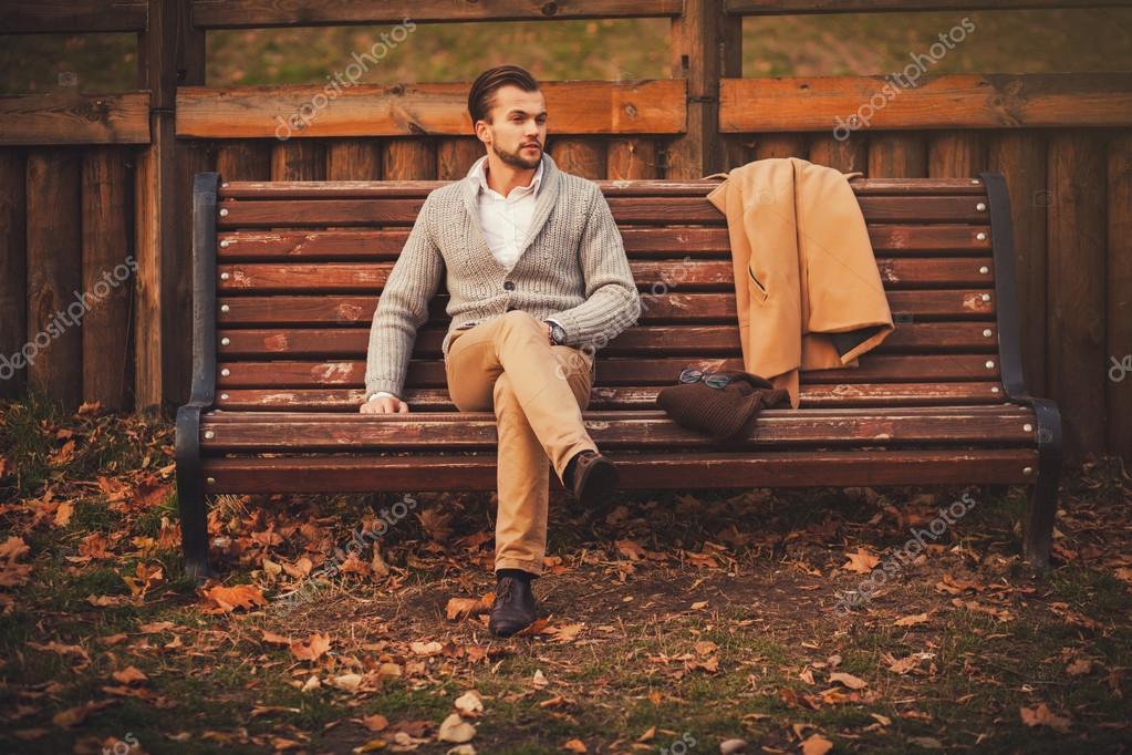 Handsome young man sitting on the bench — Stock Photo © jozzeppe #89985980