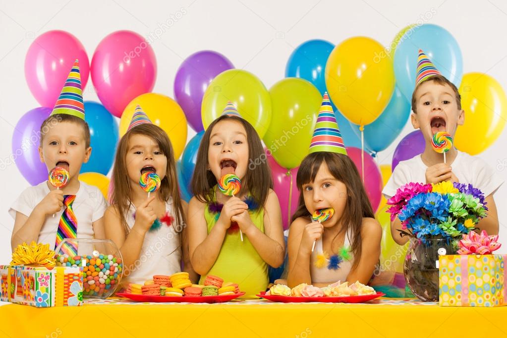 Group of joyful little kids having fun at birthday party Stock Photo by ...