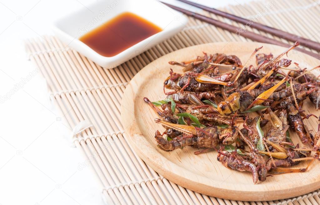 Fried grasshoppers on dish — Stock Photo © kwanchaichaiudom #117752592