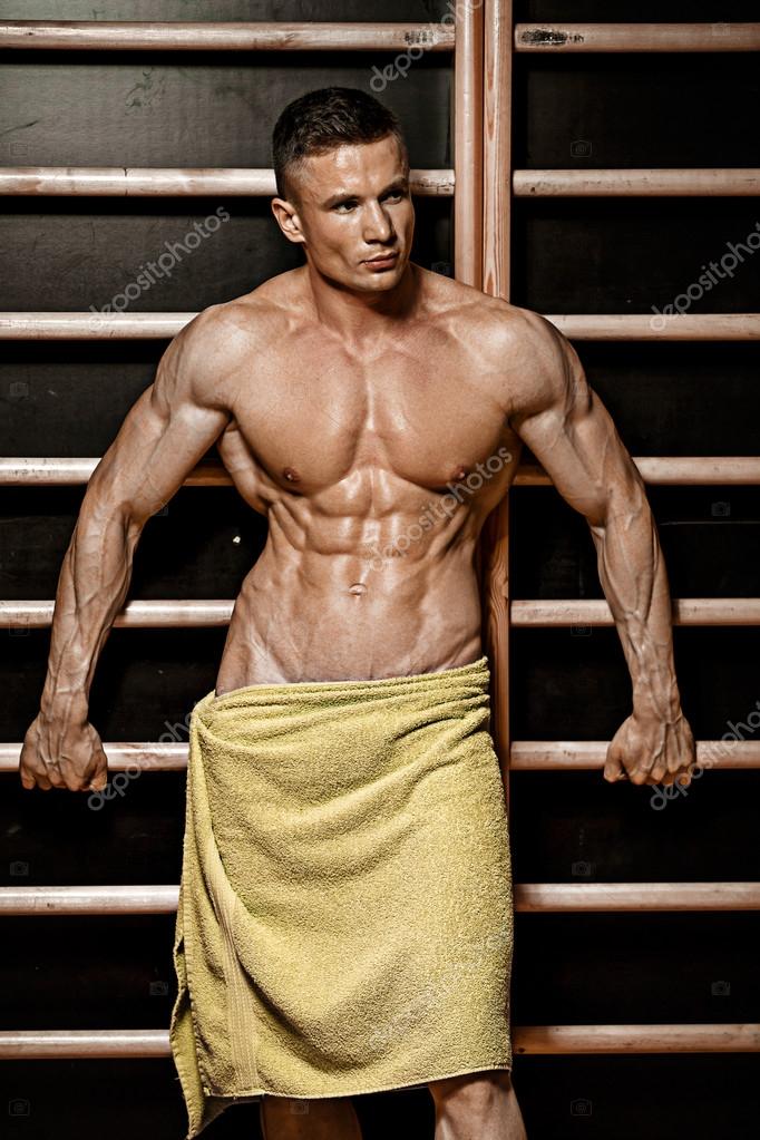 Handsome muscular man shirtless wearing white pants, in front of ...