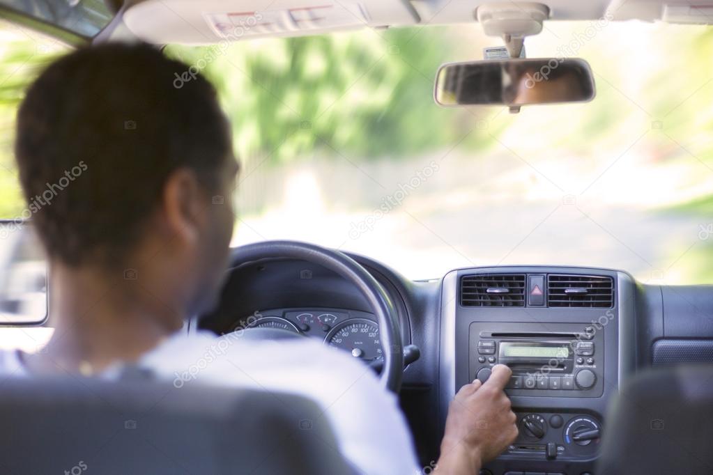 Man driving and using the radio — Stock Photo © tiagoz #115727374