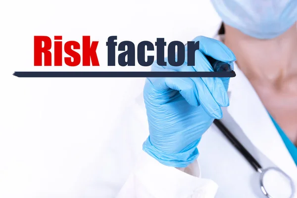 RISK FACTOR text written by a doctor hand with a stethoscope. medical ...