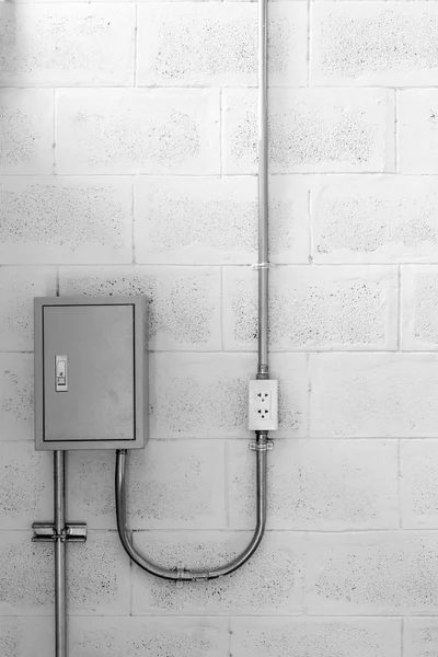 Wires and a switch on a stone wall Stock Photo by ©Himchenko 145780403