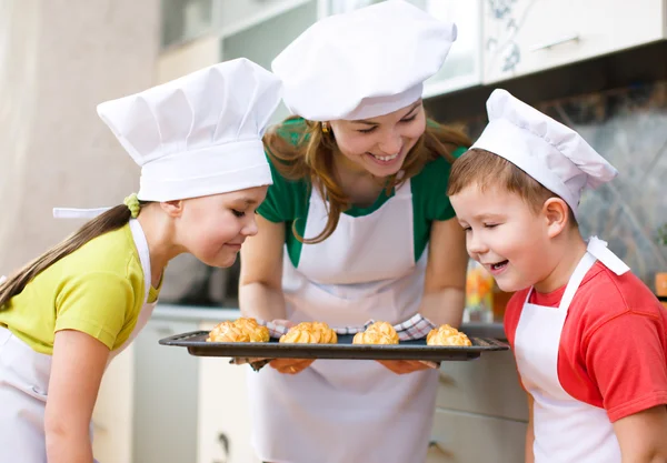 Mother with children making bread Stock Photo by ©julaszka 69786773