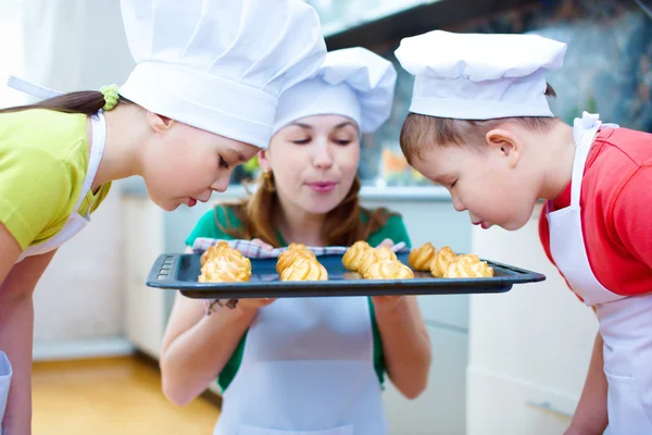 Mother with children making bread Stock Photo by ©julaszka 69786773