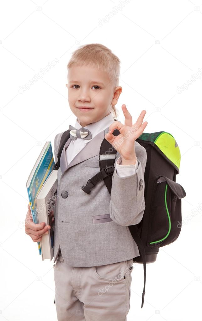 Schoolboy with a backpack, a pile of books isolated on white background ...