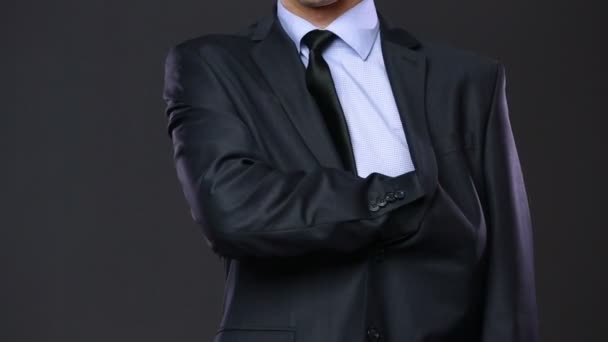 Firearms and security topic: a man in a black suit holding a gun ...