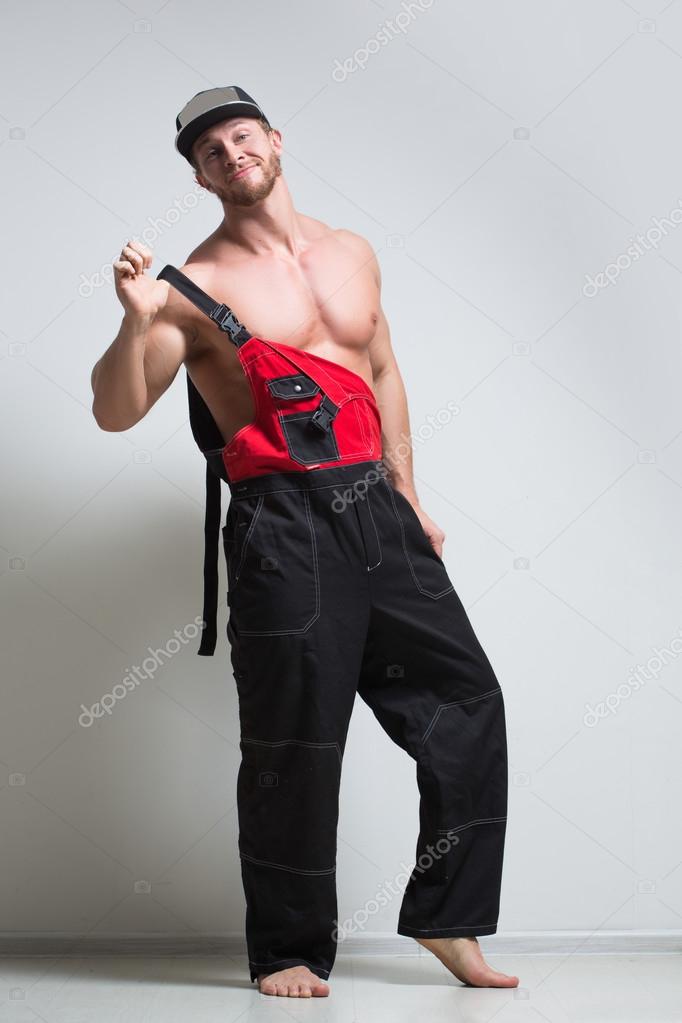 Muscular construction worker in overalls Stock Photo by ©kopitin 65176229