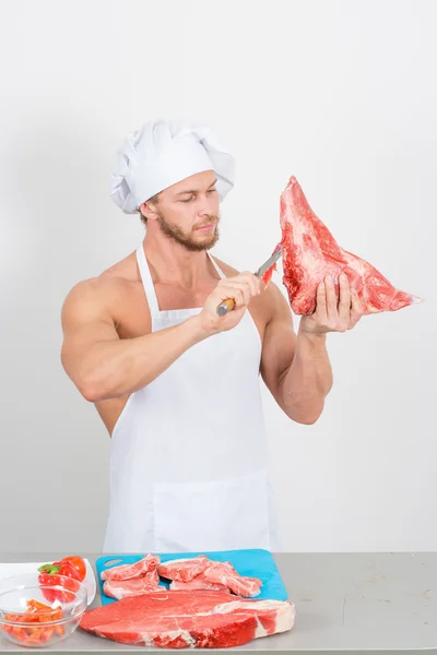 Chef bodybuilder preparing large chunks of raw meat. Stock Photo by ...