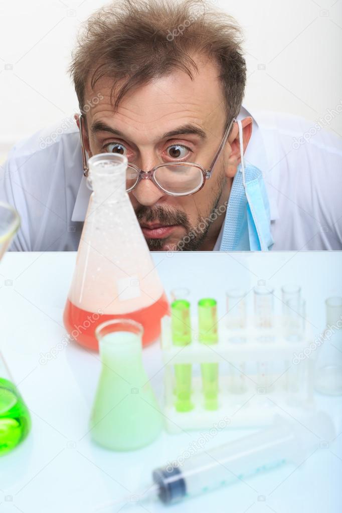 Mad chemist in the lab doing reaction — Stock Photo © kopitin #86125166