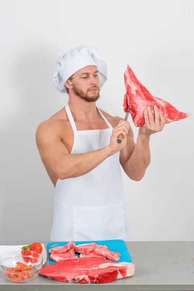 Chef bodybuilder preparing large chunks of raw meat. Stock Photo by ...