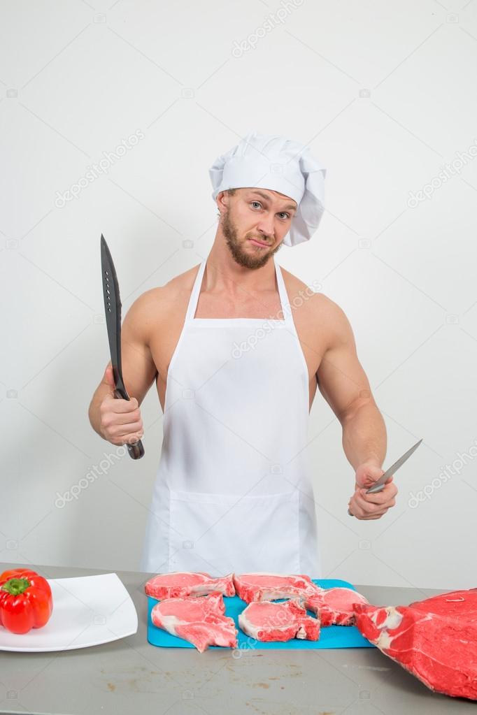 Chef bodybuilder preparing large chunks of raw meat. natural proteins ...