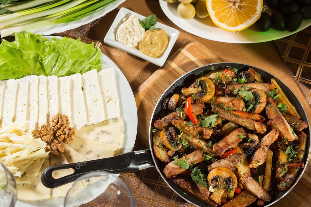 Table with normal food, steaks and potatoes. — Stock Photo © kopitin ...