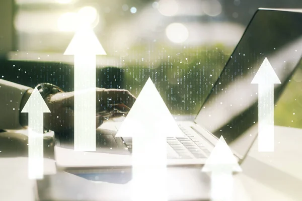 Creative abstract upward arrows hologram and hands typing on computer keyboard on background ...