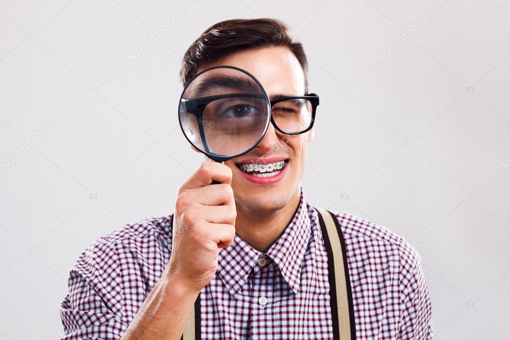 Nerd man with magnifying glass — Stock Photo © inesbazdar #85510164