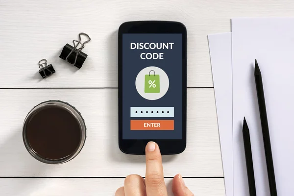 Discount code concept on smart phone screen with office objects - Stock ...