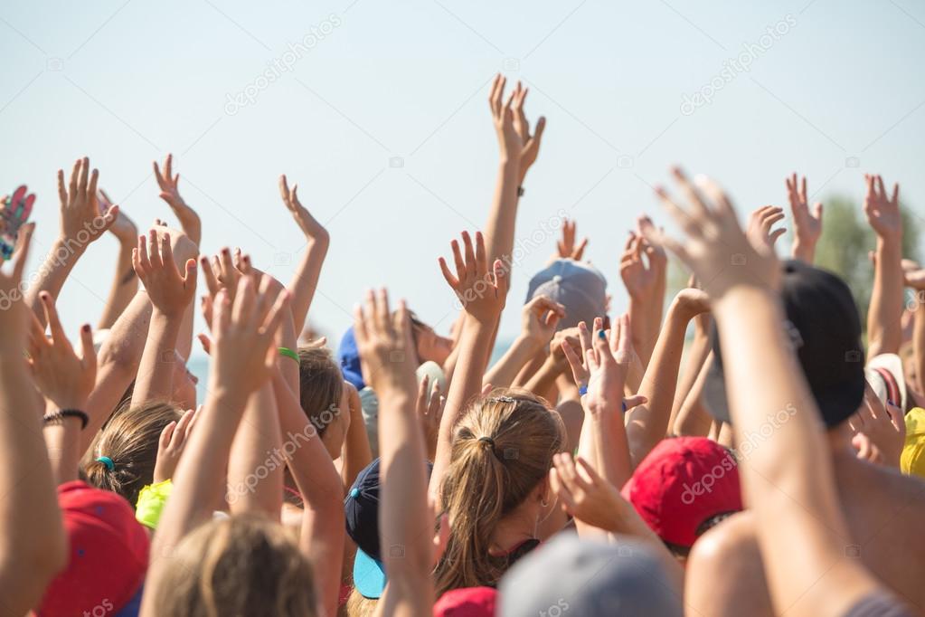 Crowd Of People With Hands Up