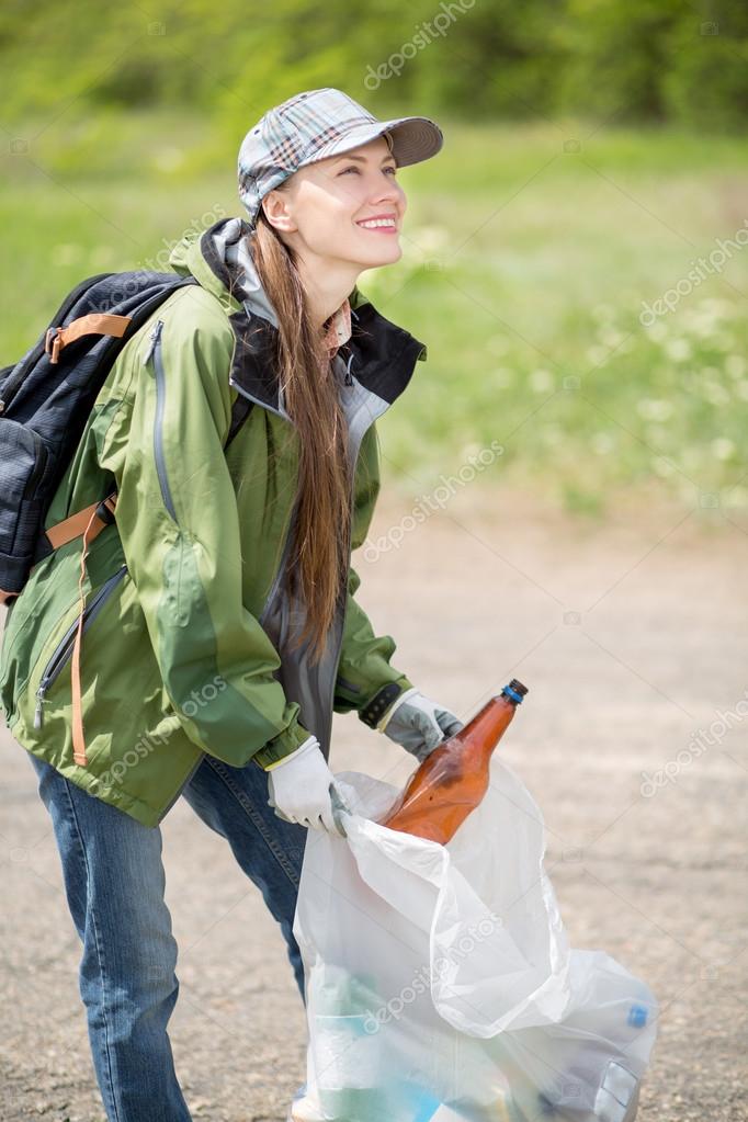 Woman picking up trash — Stock Photo © PEPPERSMINT #73058827