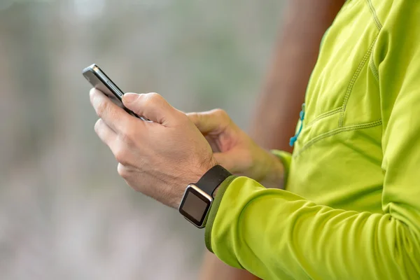 Smart watch and mobile phones. man looking on smartwatch monitor GPS ...