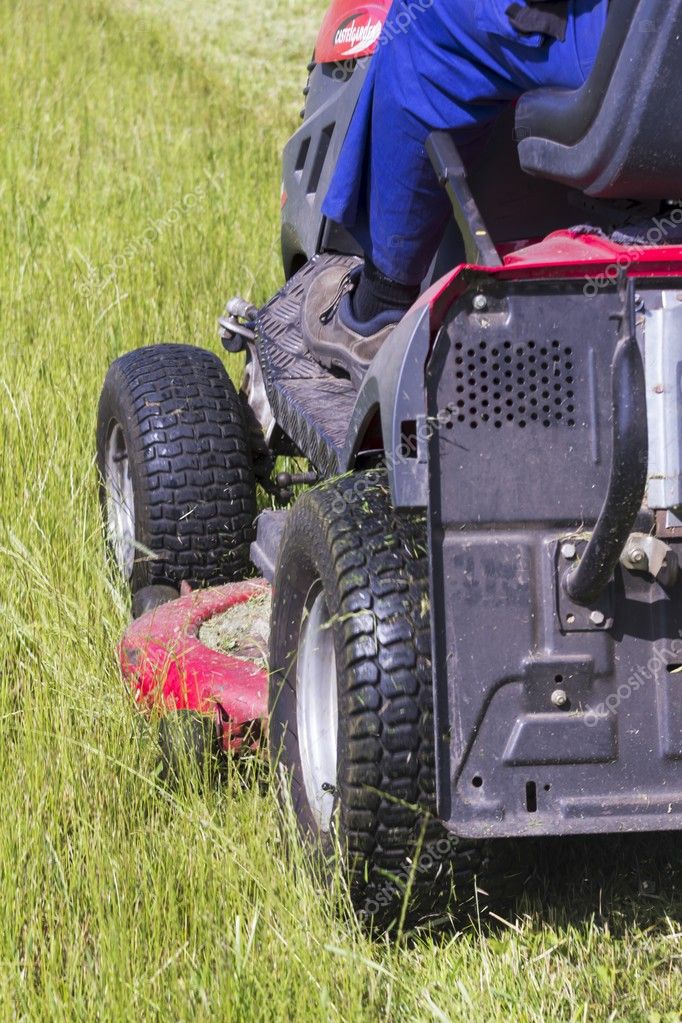 Worker slashing grass motor mower — Stock Photo © Tylinek #82911476