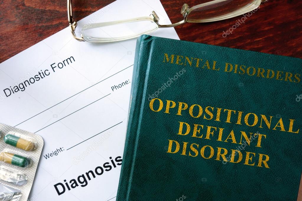 Oppositional defiant disorder concept. Diagnostic form and book on a ...